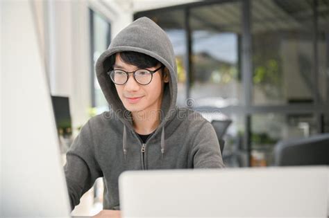 Smart And Nerd Young Asian Male Website Developer Or Programmer Working