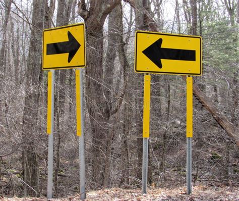 Yellow Sign With Two Arrows Pointing In Opposite Stock