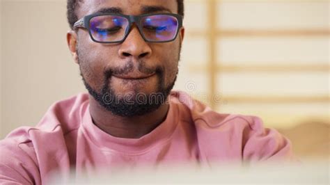 Portrait Of Focused Black Man With Eyeglasses Working With Computer