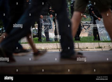 Riot Police At Protest Holding Shelter Shields And Baton Photo Trough Legs Of Walking