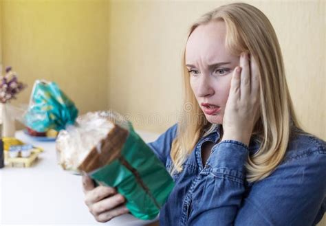 Woman Reads Instructions For Food Products At Home Checking Labels On