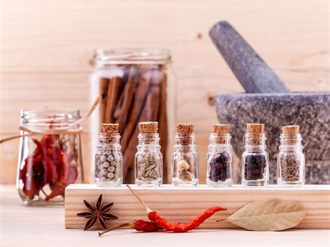 Premium Photo Close Up Of Dry And Fresh Herbs In Jar On Table