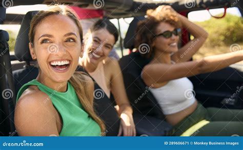 Group Of Laughing Female Friends Having Fun In Open Top Car On Road Trip Stock Image Image Of