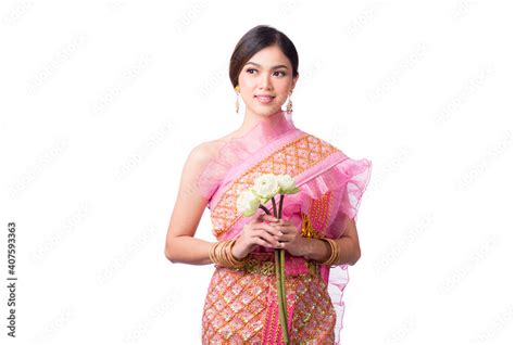 Portrait Of Beautiful Thai Girl In Traditional Costume With A Lotus Flower In His Hand On White