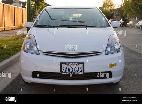 Front View Of A White Toyota Prius With A Sav3 Gas Save Gas License
