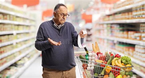 Ature Man In A Supermarket Holding A Bill Stock Photo Image Of Adult Elderly