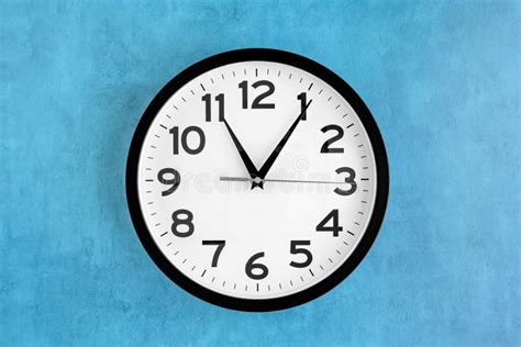 Modern Analog Clock Round In Black And White On A Blue Background