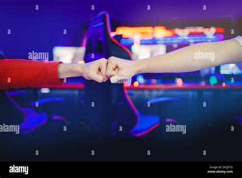 Professional Gamer Greeting And Support Team Fists Hands Online Game In Neon Color Blur