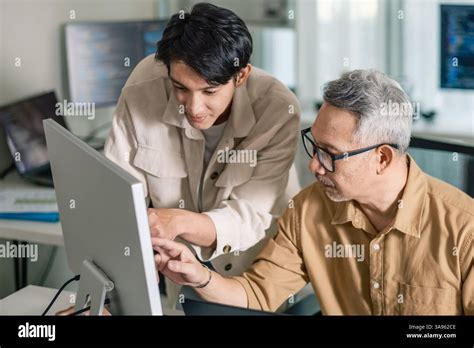 Group Of Asian Senior Learning Programming Software Development Analyzing Flowcharts During A