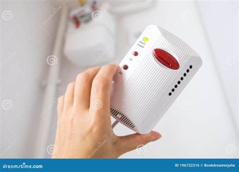 Typical Gas Sensor In Europe White Gas Detector Device In Hand To Prevent Gas Leaks And Provide