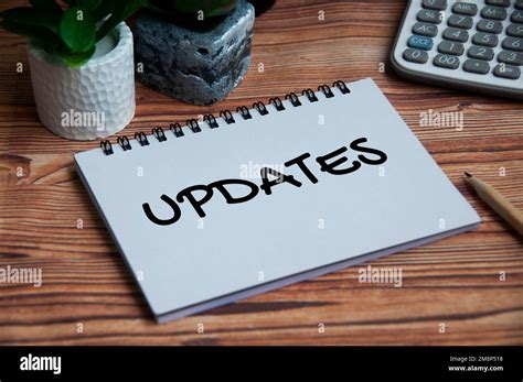 Updates Text On Notebook With Green Plant And Calculator Background