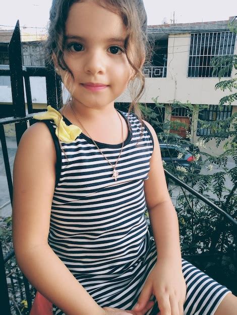 Premium Photo Portrait Of Girl Sitting In Balcony
