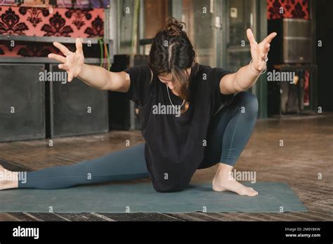 Woman Yogi New Teacher Young Adult Balancing A Skandasana Pose