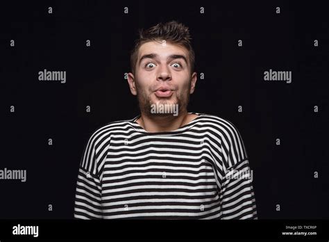 Close Up Portrait Of Young Man Isolated On Black Studio Background