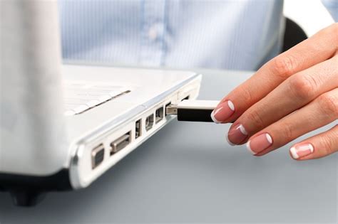 Premium Photo Female Hand Inserting Flash Drive Woman Inserts Flash Drive Extra Information