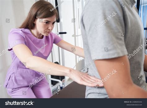 Woman Doctor Examining Male Patient Physical Stock Photo