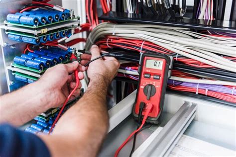 Premium Photo Close Up Of Man Using Voltmeter In Factory