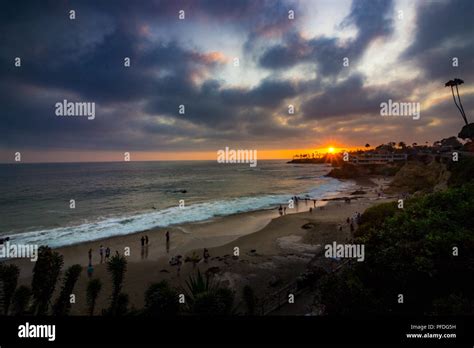 Stunning Coastal View Of A Cloudy Sky With Waves Crashing Onto The
