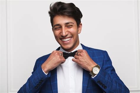 Premium Photo Man Adjusting Bow Tie Smiling