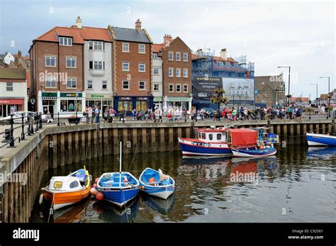 Holiday Makers In Whitby Harbour Crabbing Over The Wall North Yorkshire