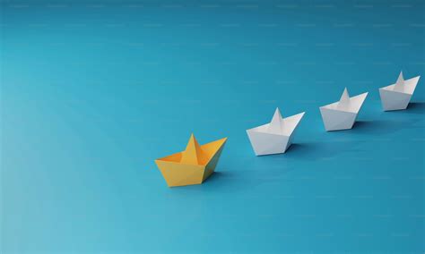 노란 종이 배를 든 지도자는 파란 배경에 하얀 배를 이끌고 있다 비즈니스 리더십 3d 렌더링 그림입니다 사진 Unsplash의 배 이미지