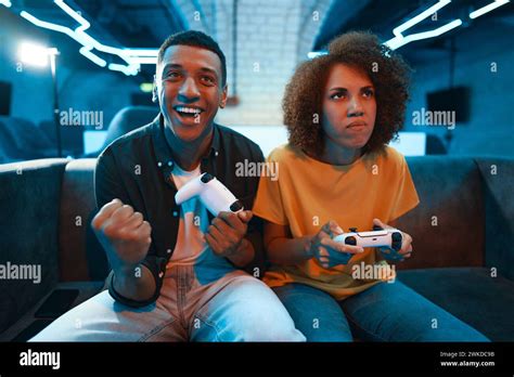 Man And Woman Play Console And Show Emotions Stock Photo Alamy