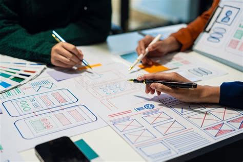 Ux Developer And Ui Designer Brainstorming About Mobile App Interface Wireframe Design With