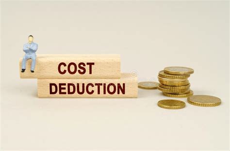 On The Table Are Coins Wooden Plates With The Inscription Cost