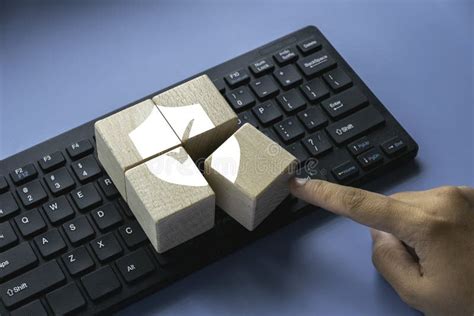 Wooden Cube With Shield Logo And Check Mark Over A Computer Keyboard Wooden Cube With Shield Logo And Check Mark Over A Computer Keyboard