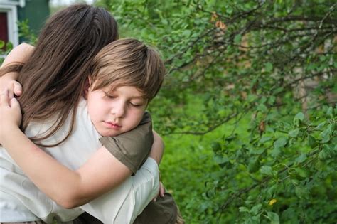 Premium Photo Mother And Son In A Candid Moment At A Park Embodying The Essence Of Familial