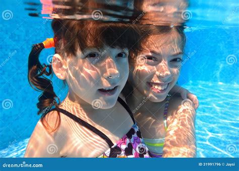 Happy Girls Swim Underwater In Pool Royalty Free Stock Image Image