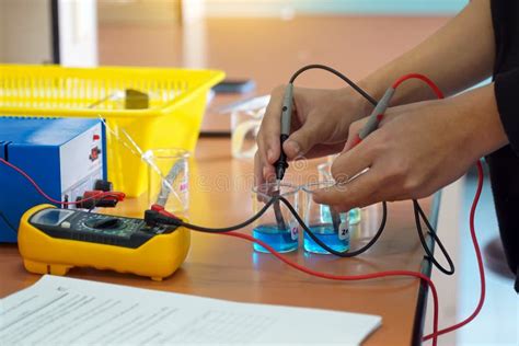 Students Use A Digital Multimeter To Measure Electrical Potential