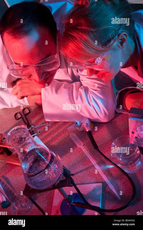 Woman And Man In Lab Coats With Lab Equipment Red And Blue Light Stock Photo Alamy