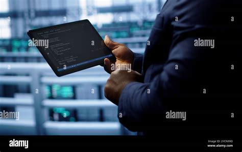 Engineer In High Tech Facility Using Tablet To Patch Network Issues