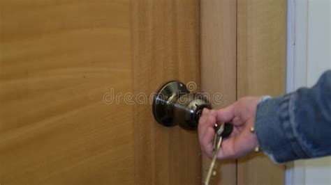 Woman Using A Key To Open The Lock Of The Front Door Woman Returns Home A Girl Enters The Room