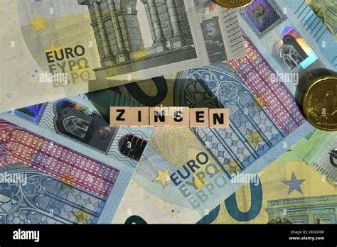 The German Word For Interest With Wodden Cubes And Euro Bills Stock