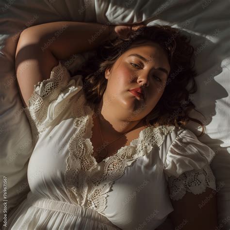 Cute Caucasian Plus Size Girl Lying On The Bed Golden Hour Lighting