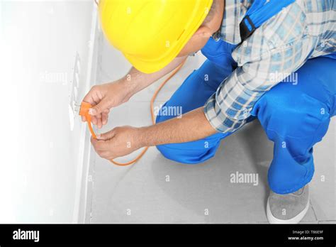 Male Electrician Inserting Plug Into Socket In Order To Check Its Serviceability Stock Photo Alamy