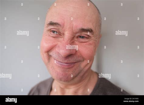 Face Of European Old Man Close Up Wrinkles On Aging Skin Smiling