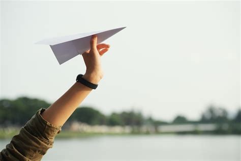 Free Photo Closeup Of A Teenage Hand Throwing The Paper Plane