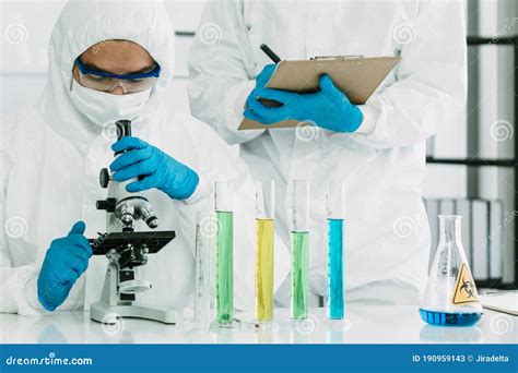 Lab Technician In Personal Protective Equipment PPE Suit Okey Hand Gesture Stock Image