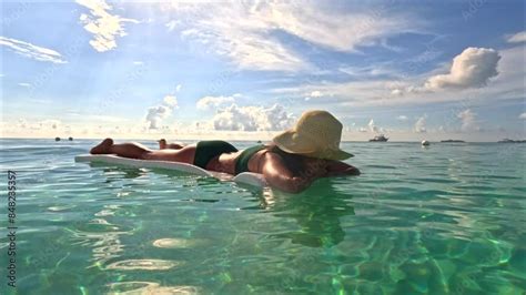 Beautiful Woman Sunbathing On Caribbean Sea With Clear Sky And Stunning