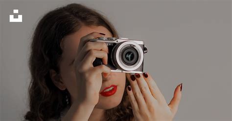 흰색 니트 스웨터를 입은 여자가 은색과 검은색 카메라를 들고 있다 사진 Unsplash의 무료 런던 이미지