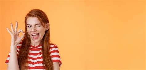 Premium Photo I Got Under Control Sly Creative Redhead Cheerful Girl Assuring You Everything