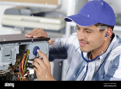 Man Fixing Computer With An Stethoscope Stock Photo Alamy