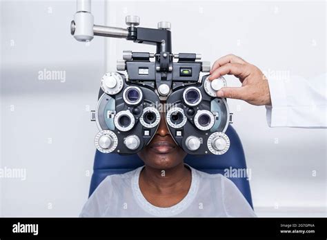 Optometrist Adjusting The Optometry Equipment During Study Of The