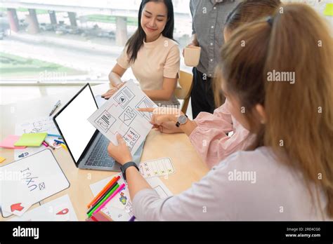 Ux Developer And Ui Designer Presenting And Testing Mobile App Interface Designin Meeting At