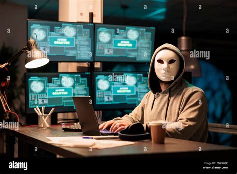 Hacker Wearing Mask And Hood To Hack Computer System Breaking Into Company Servers To Steal Big