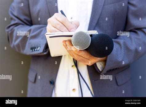 Journalist At News Conference Or Media Event Holding Microphone