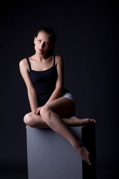 Premium Photo Studio Shot Of Sexy Young Model Sitting On Cube